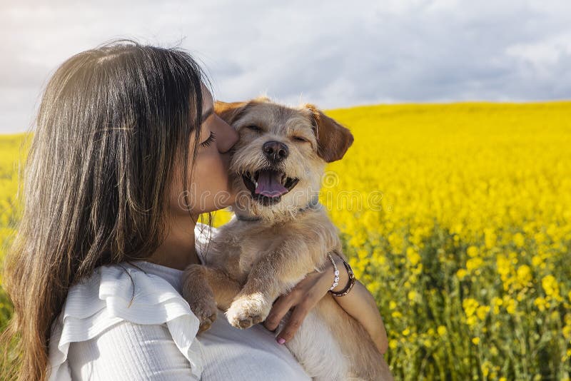 Young Woman Giving a Kiss To Her Happy Dog, Nature Background. Stock ... Young Woman Giving a Kiss To Her Happy Dog, Nature Background. Stock ...