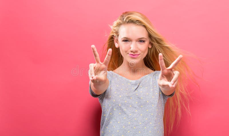 Young Woman Giving the Peace Sign Stock Image - Image of cheerful ... Young Woman Giving the Peace Sign Stock Image - Image of cheerful ...