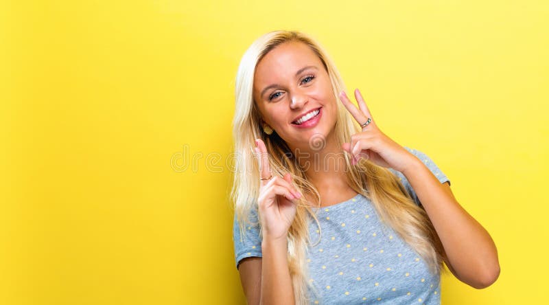 Young Woman Giving The Peace Sign Stock Image - Image of smile ... Young Woman Giving The Peace Sign Stock Image - Image of smile ...