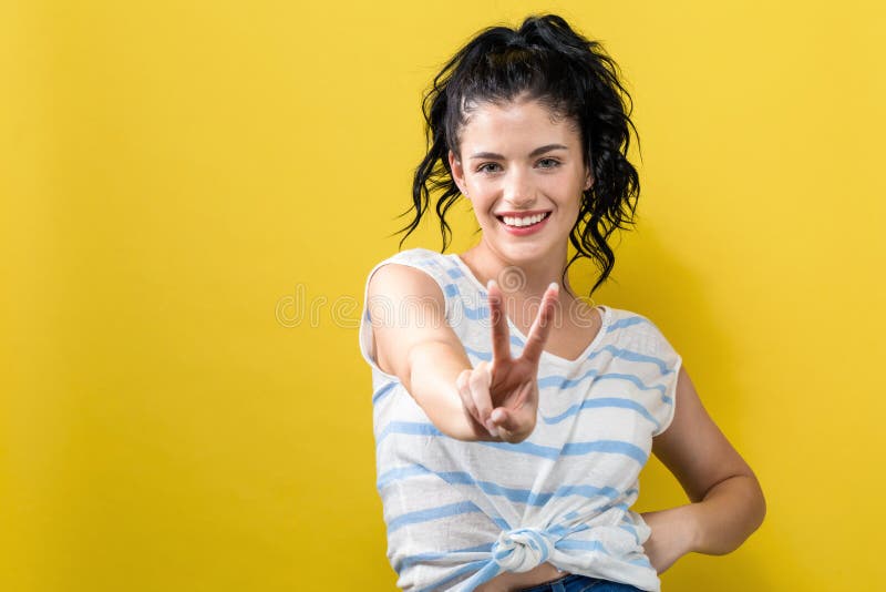 Young Woman Giving the Peace Sign Stock Photo - Image of summer, adult ... Young Woman Giving the Peace Sign Stock Photo - Image of summer, adult ...