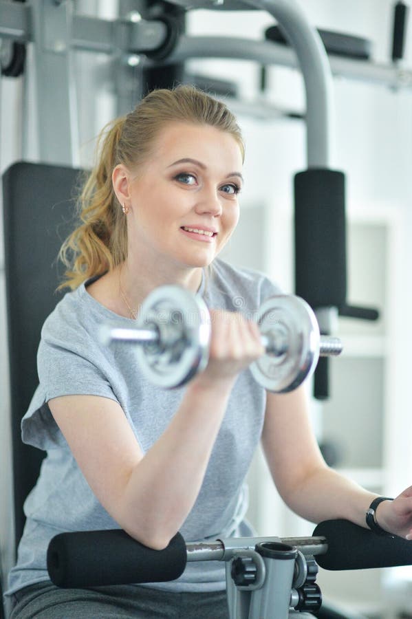 Young Woman in a Gym with a Dumbbell Stock Photo - Image of strong ...