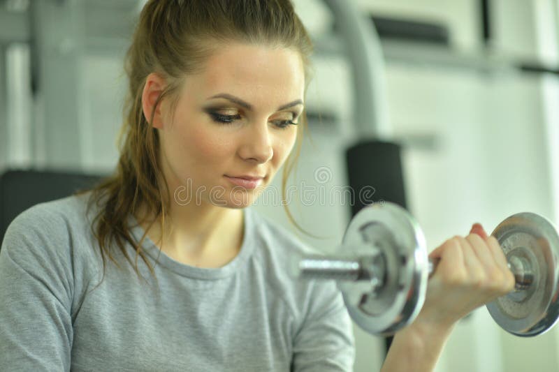 Young Woman in a Gym with a Dumbbell Stock Photo - Image of body ...