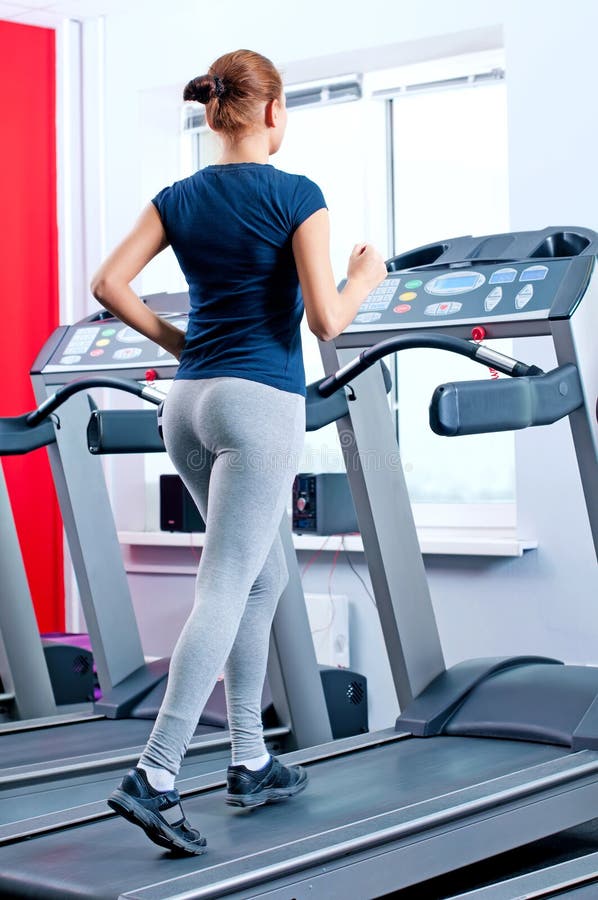 Young Woman at the Gym Run on on a Machine Stock Photo - Image of ...