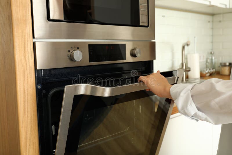Young Woman Hand Open Modern Oven in Kitchen Stock Photo - Image of ...