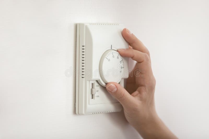 Young Woman Hand Switch on Temperature Regulator on Wall Panel Stock ...