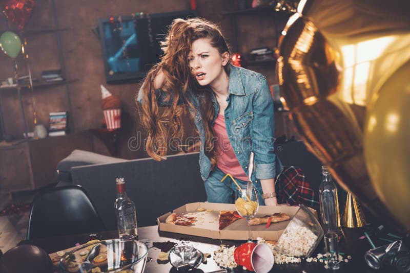 Young Woman with Hangover Leaning at Messy Table after Party Stock ...