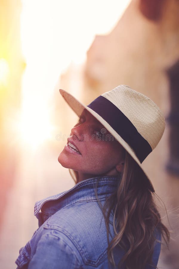 Young Woman in Hat Looking Back in Sunset Stock Photo - Image of woman ...