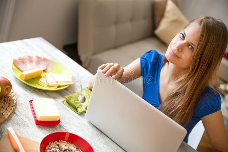 Young Woman Having Breakfast while Using a Laptop Computer Stock Image ...
