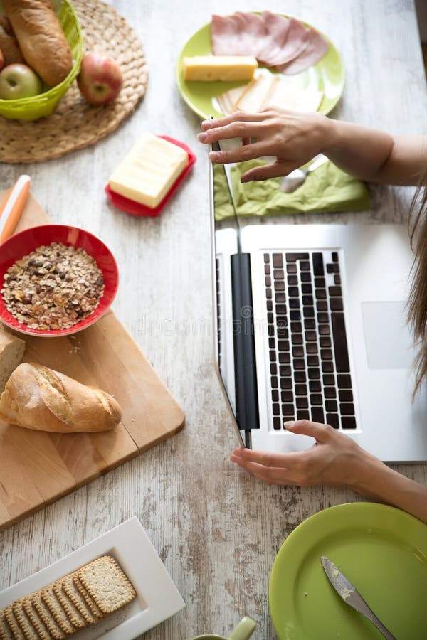 Young Woman Having Breakfast while Using a Laptop Computer Stock Image ...