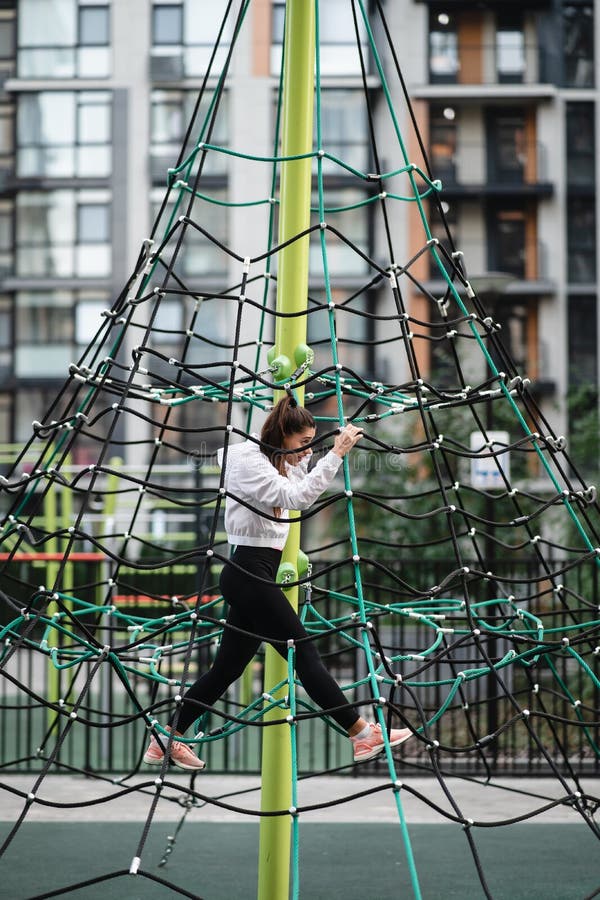 Young Woman Having Fun on the Rope Pyramid Stock Photo - Image of ...