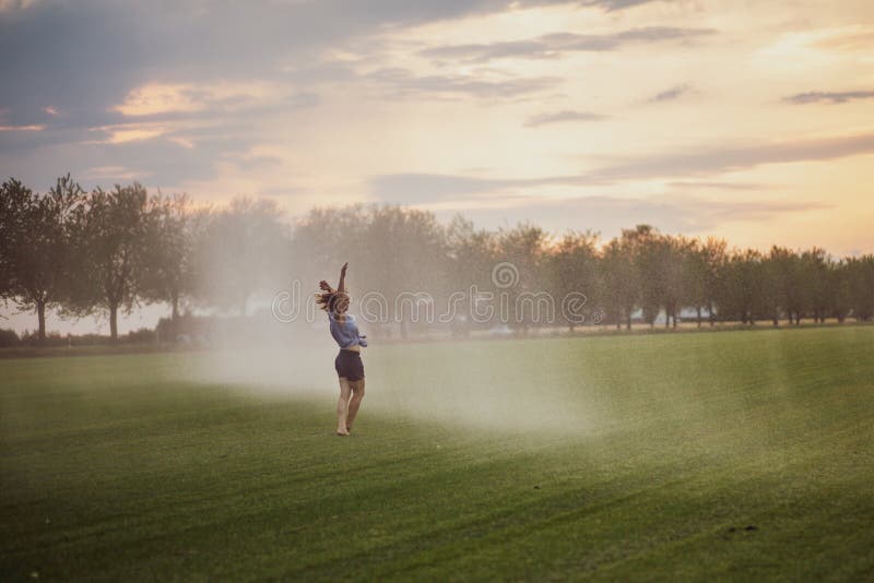 Young Woman Having Fun with Water from a Sprinkler Stock Photo - Image ...