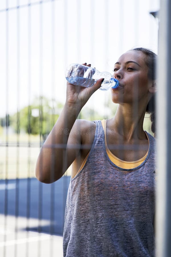 Young Woman Having Refreshment during Training Stock Image - Image of ...