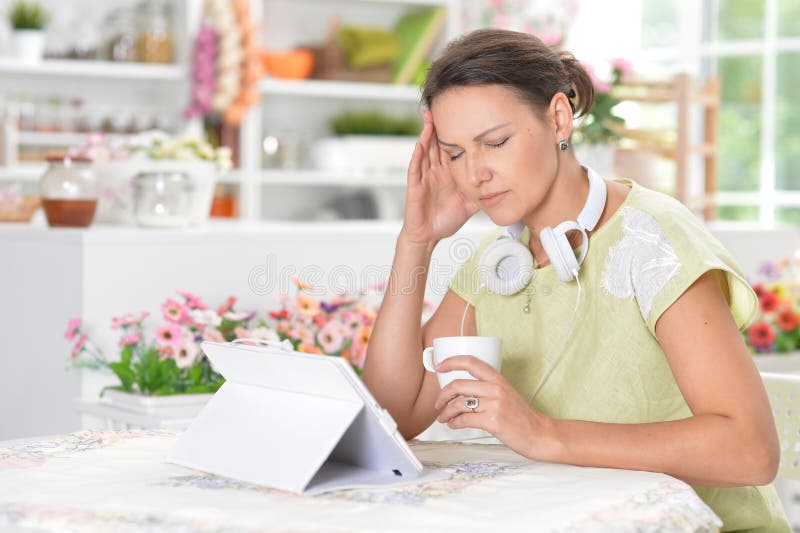 Young Woman with Headache Using Digital Tablet Stock Photo - Image of ...