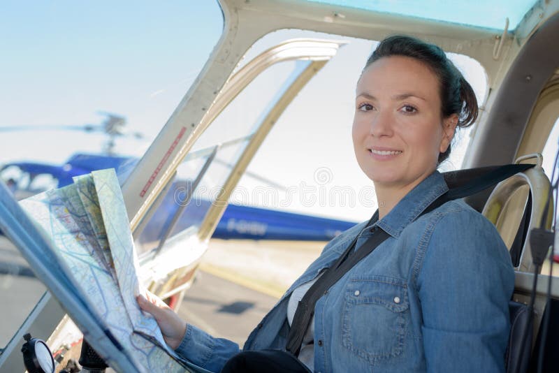 Young Woman Helicopter Pilot Reading Map Stock Image - Image of display ...
