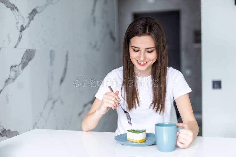 Young Woman in Her Country Kitchen with a Coffee and Cake Stock Photo ...