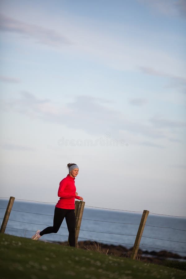 Young Woman on Her Evening Jog Stock Photo - Image of jogging, happy ...