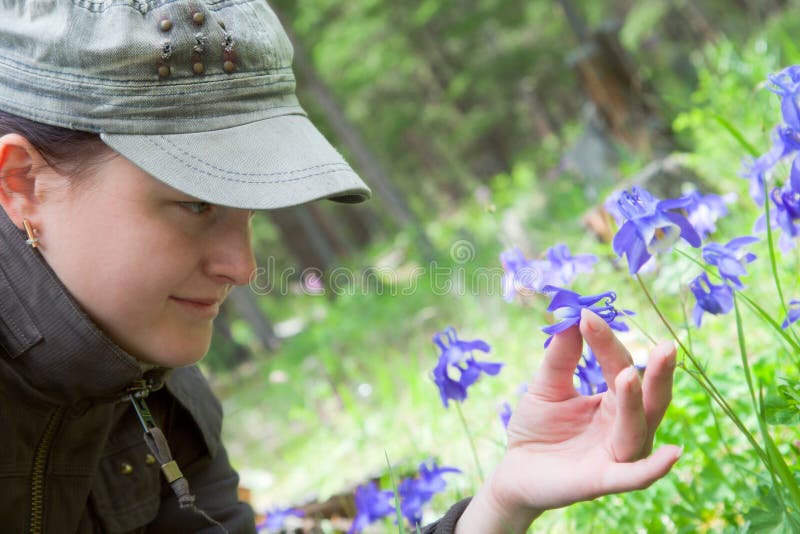 Young Woman Holding a Blue Flower in the Hands of Stock Image - Image ...