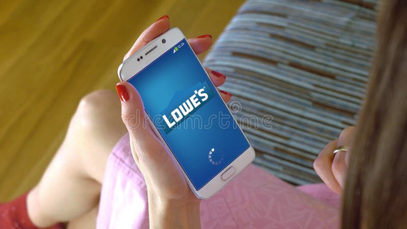 Young Woman Holding a Cell Phone with Loading Lowe`s Mobile App. Conceptual Editorial CGI ...