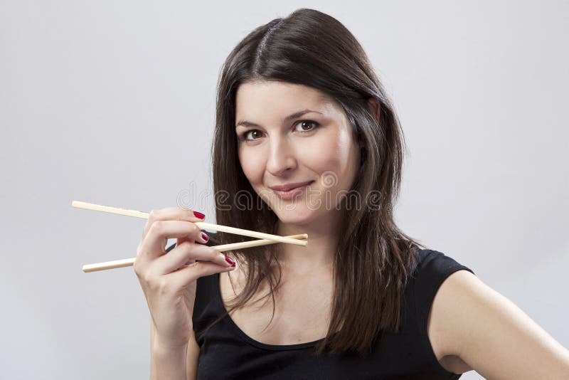 Young Woman Holding Chopsticks Stock Image - Image of good, happy: 16652133