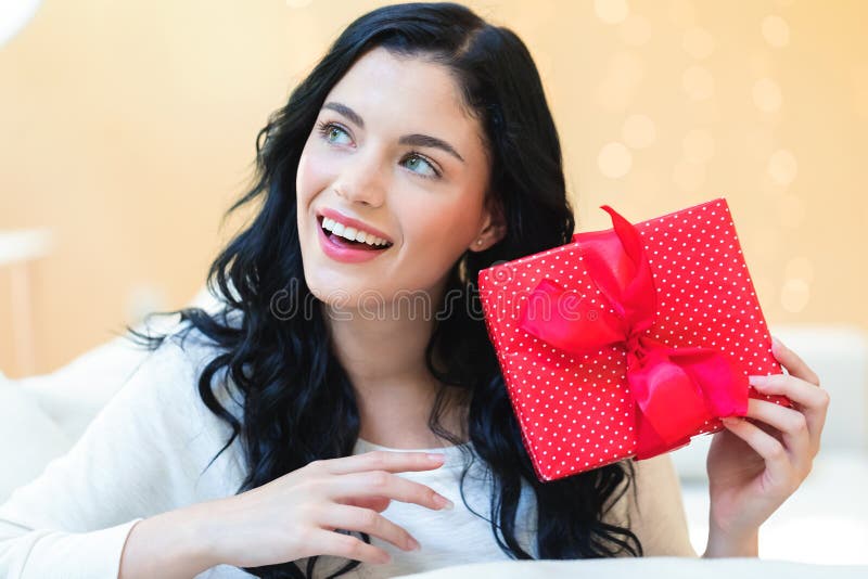 Young Woman Holding a Gift Box Stock Photo - Image of attractive, house ...