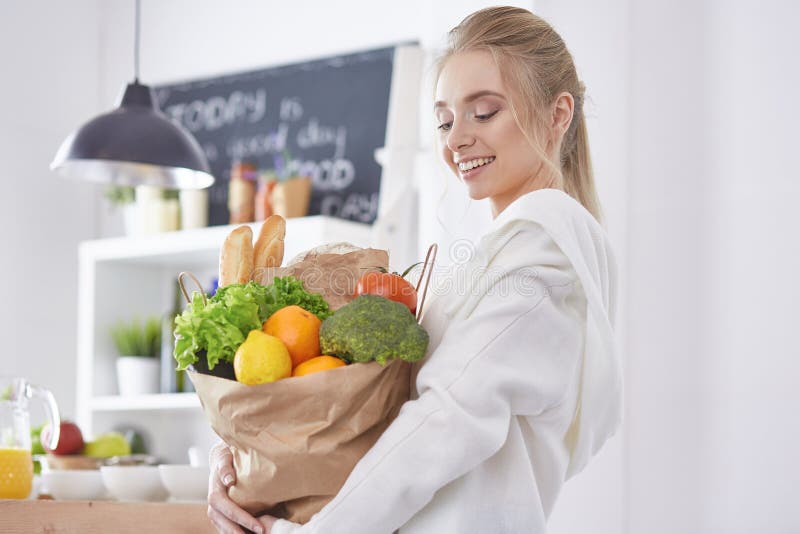 Young Woman Holding Grocery Shopping Bag with Vegetables Standi Stock ... Young Woman Holding Grocery Shopping Bag with Vegetables Standi Stock ...