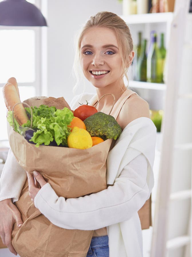 Young Woman Holding Grocery Shopping Bag with Vegetables Standi Stock ... Young Woman Holding Grocery Shopping Bag with Vegetables Standi Stock ...