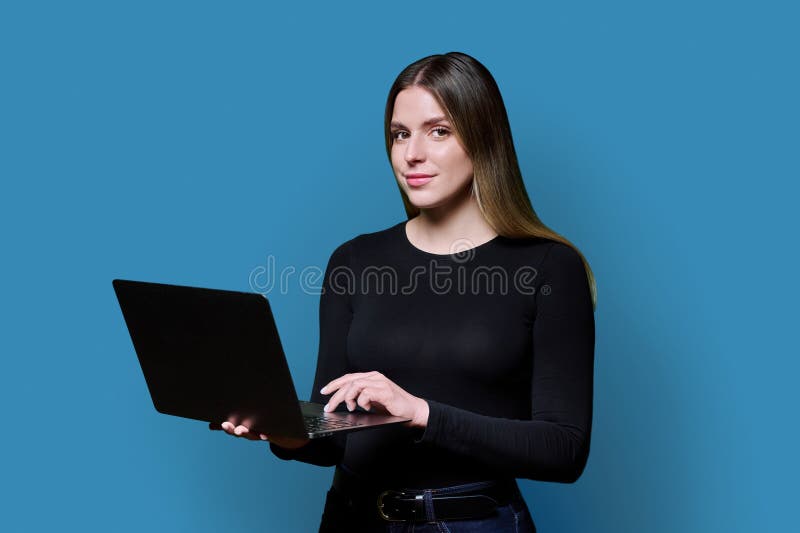 Young Woman Holding Laptop on Blue Studio Background Stock Image ...