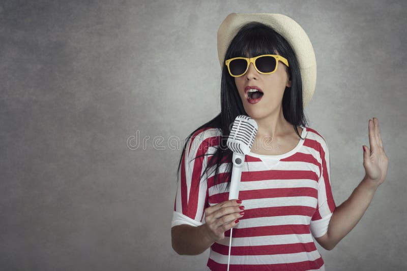Young Woman Holding a Microphone Singing Stock Image - Image of ...