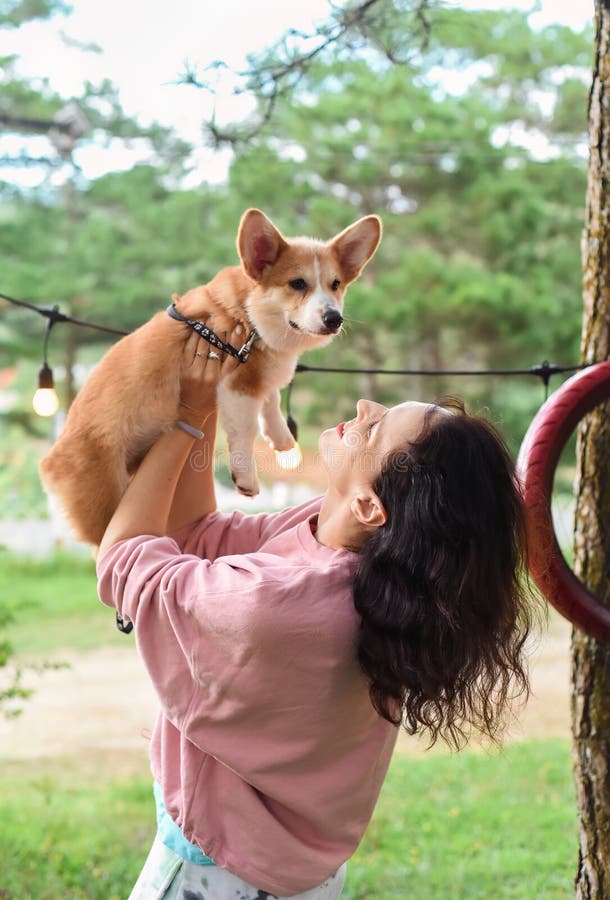 Young Woman Hugging Her Corgi Dog in the Forest Stock Image - Image of ...