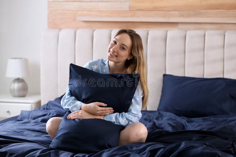 Young Woman Hugging Pillow on Bed with Silky Linens Stock Photo - Image ... Young Woman Hugging Pillow on Bed with Silky Linens Stock Photo - Image ...