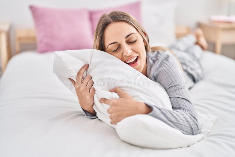 Young Woman Hugging Pillow Lying on Bed at Bedroom Stock Photo - Image ...