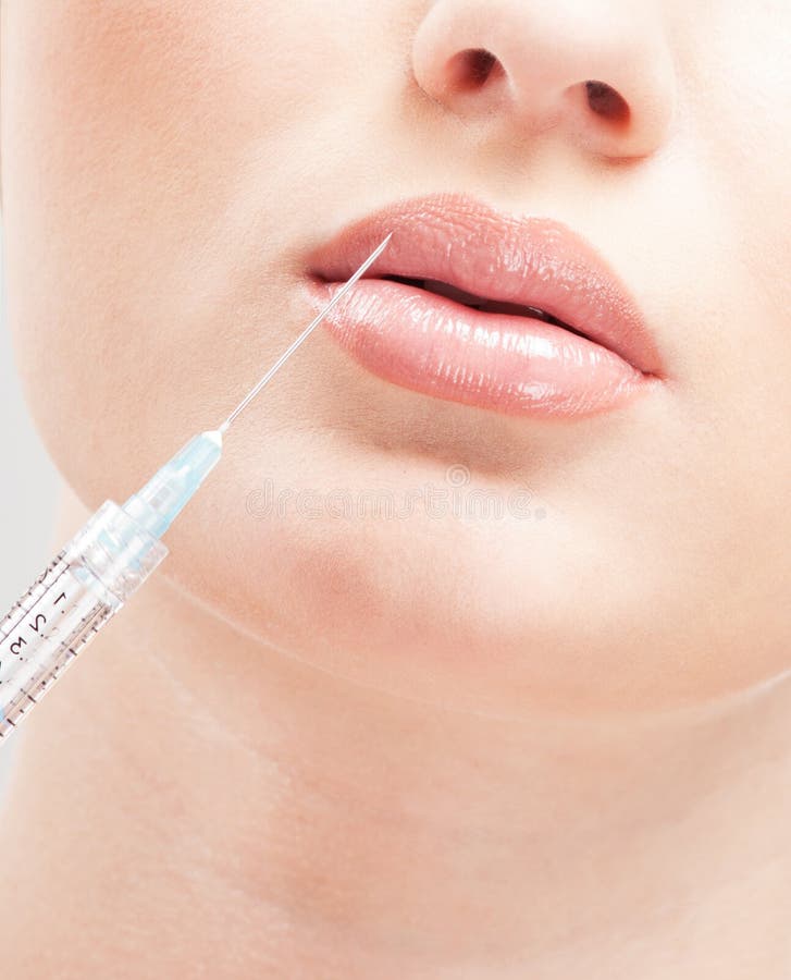 A Young Woman Injecting Botox into Her Lips Stock Image - Image of ...