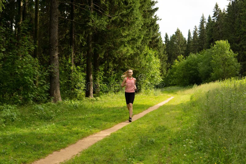 Young Woman Jogging in the Forest Stock Image - Image of attractive ...