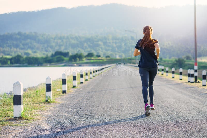 Young Woman Jogging in Nature Stock Photo - Image of fitness, girl ...