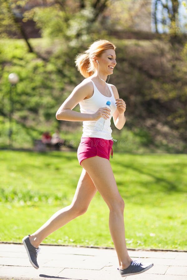 Young Woman Jogging in Park Stock Photo - Image of jogging, sportswear ...