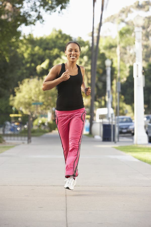 Young Woman Jogging on Street Stock Photo - Image of person, happy ...