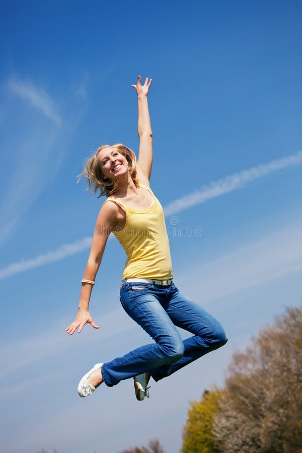 Young woman jumping high stock photo. Image of blond - 15520014