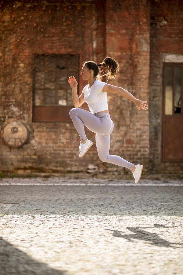 Young Woman Juping High during Training in the Urban Environment Stock ...