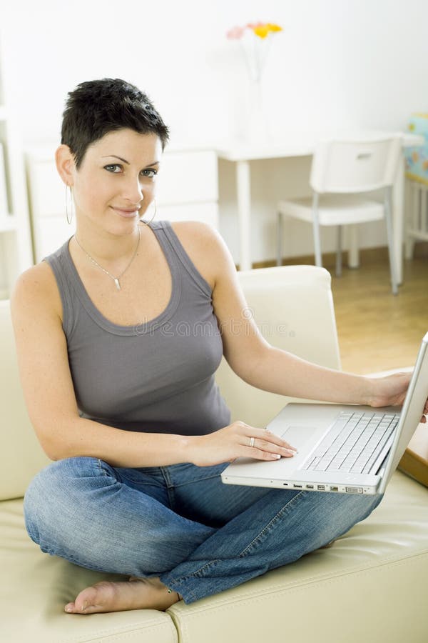 Attractive Single Woman Browsing a Dating Site on Her Computer Indoors ...