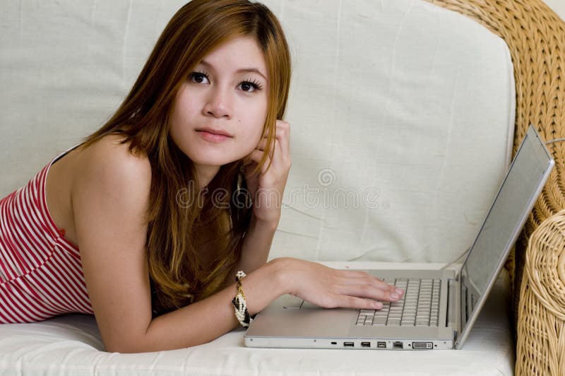 Young Woman Laying Down with Computer Stock Photo - Image of confidence ...
