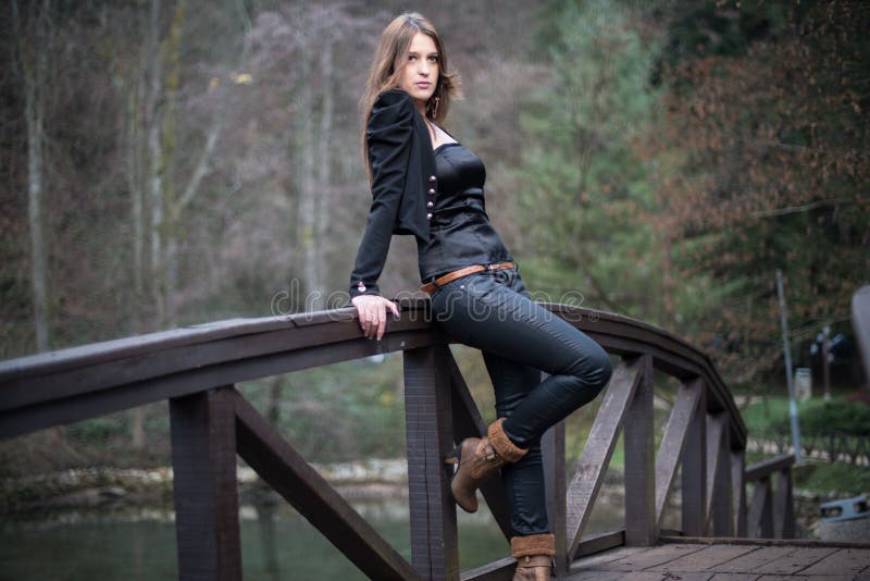 Young Woman Leaning at the Bridge Stock Photo - Image of park, fall ...