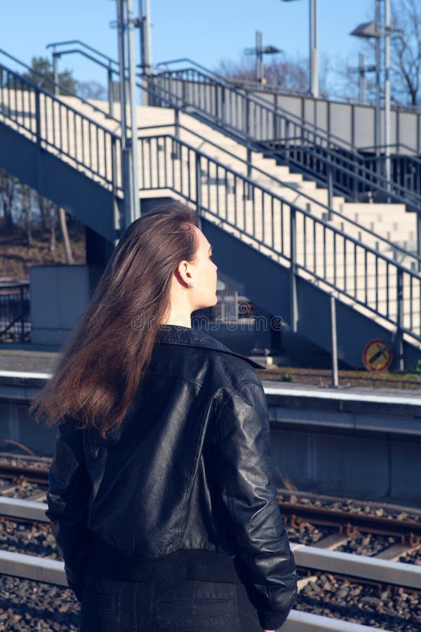 Young Brunette Woman in Leather Jacket Waiting on Platform at Train ...