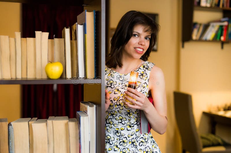 Young woman in library stock photo. Image of woman, book - 70132752