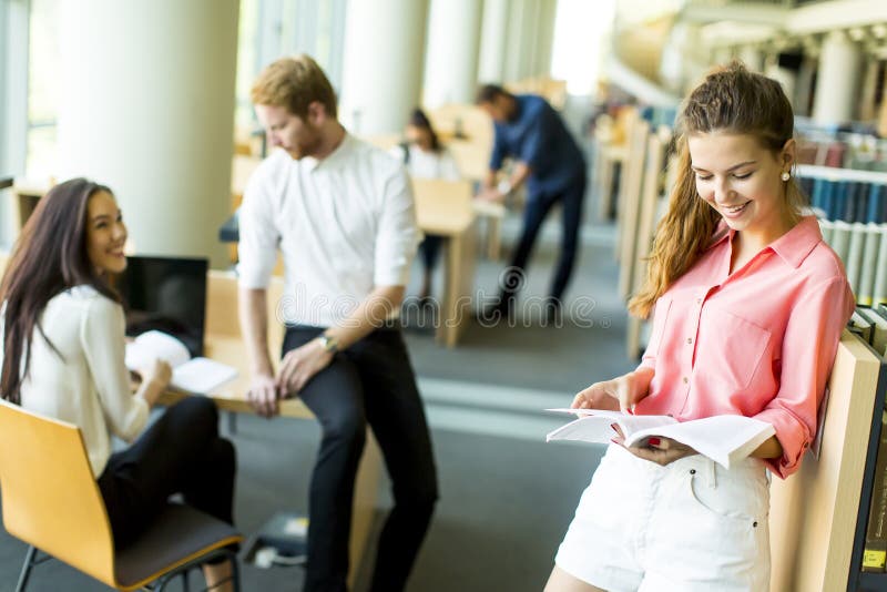 Young woman in the library stock image. Image of choose - 60069125