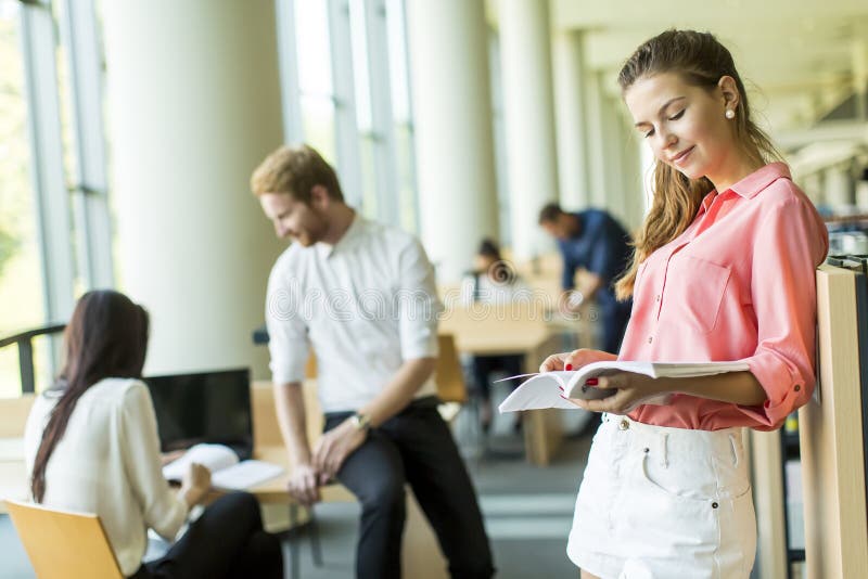 Young woman in the library stock image. Image of books - 60333993