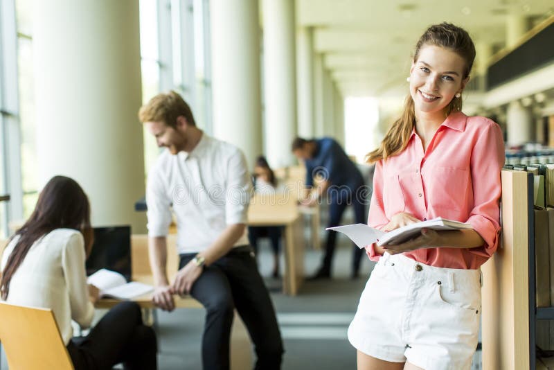 Young woman in the library stock photo. Image of female - 60334100
