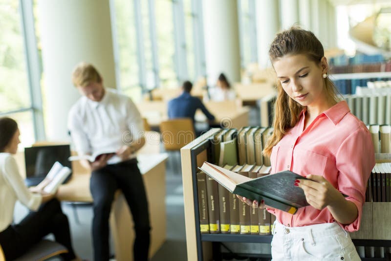 Young woman in the library stock photo. Image of bookcase - 60334138