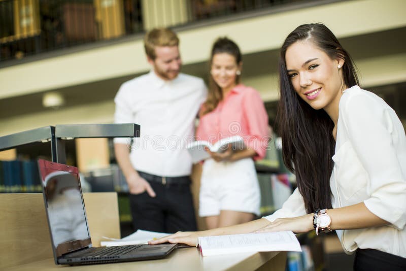 Young woman in the library stock image. Image of standing - 61310439