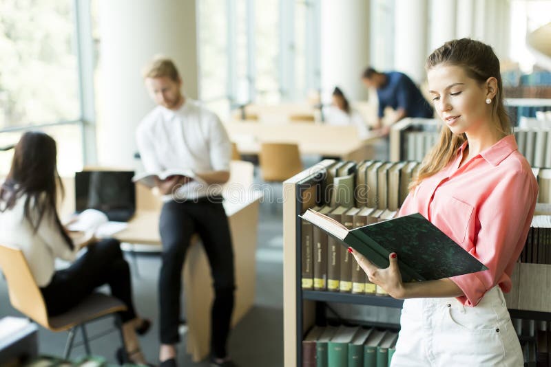 Young woman in the library stock image. Image of young - 73284615