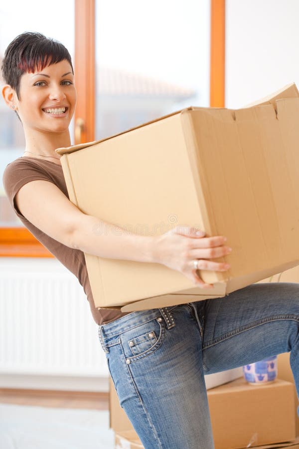 Young Woman Lifting Cardboard Box Stock Photo - Image of happy, hair ...